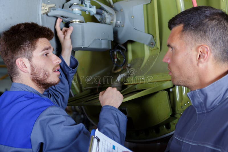 Two Factory Workers Working on Machine Stock Image - Image of cheerful ...