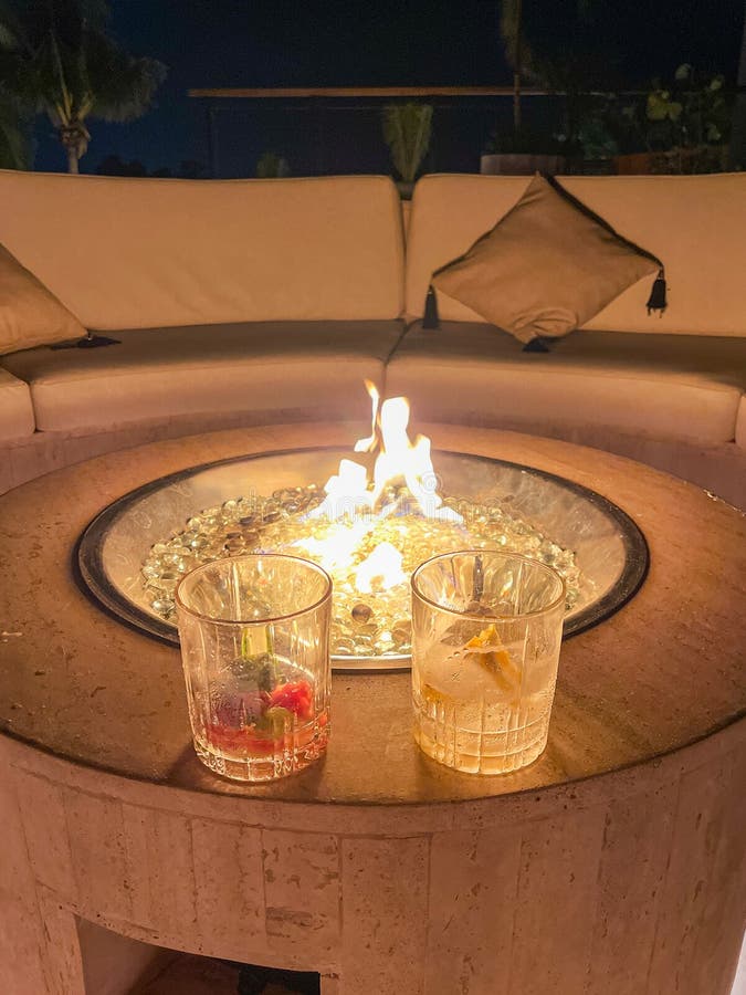 Two Fancy Drinks in Front of a Propane Gas Fire Pit at an Outdoor Bar ...