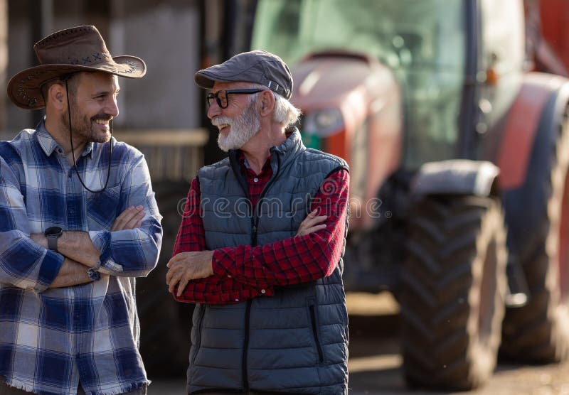 Two Farmers in Front of Tractor on Cattle Farm Stock Image - Image of ...