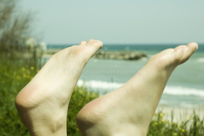 Two Feet in the Air stock image. Image of grass, feet, shore - 732583