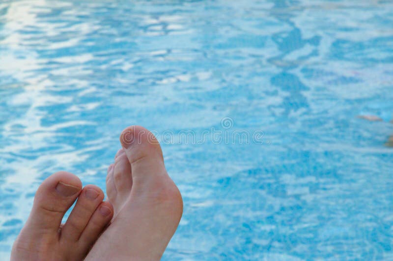 Two Feet in Front of Blue Water Stock Photo - Image of luxury, leisure ...