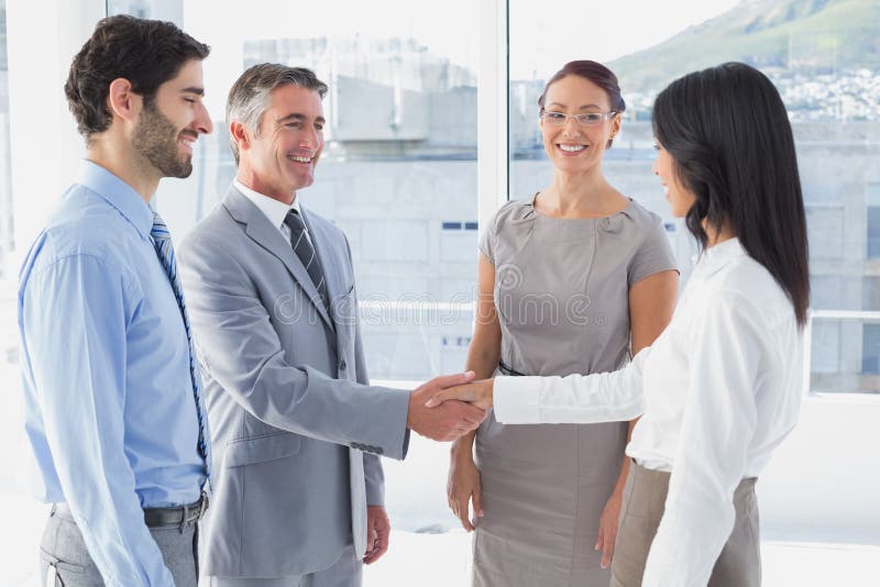 Two Fellow Employees Shaking Hands Stock Photo - Image of four, middle ...