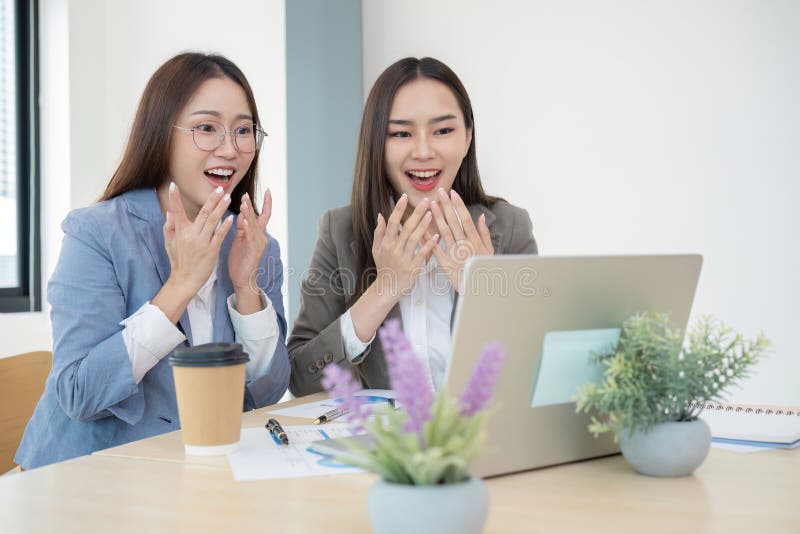 Two Female Accountant Collaborating on Financial Graphs and Data ...