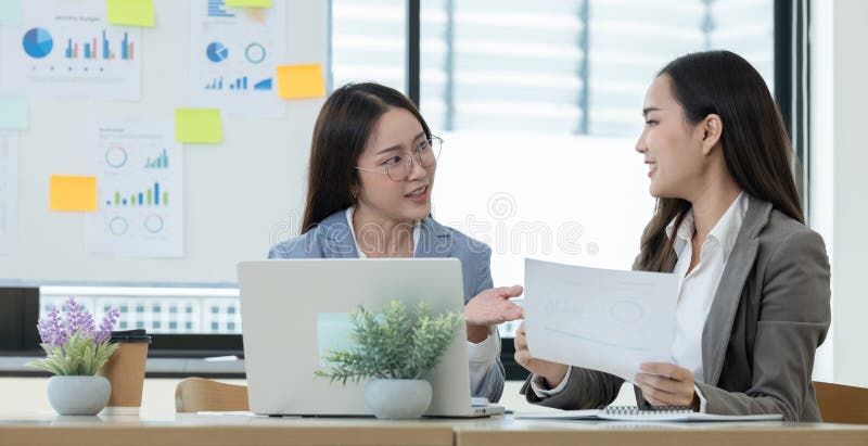 Two Female Accountant Collaborating on Financial Report in a Modern ...