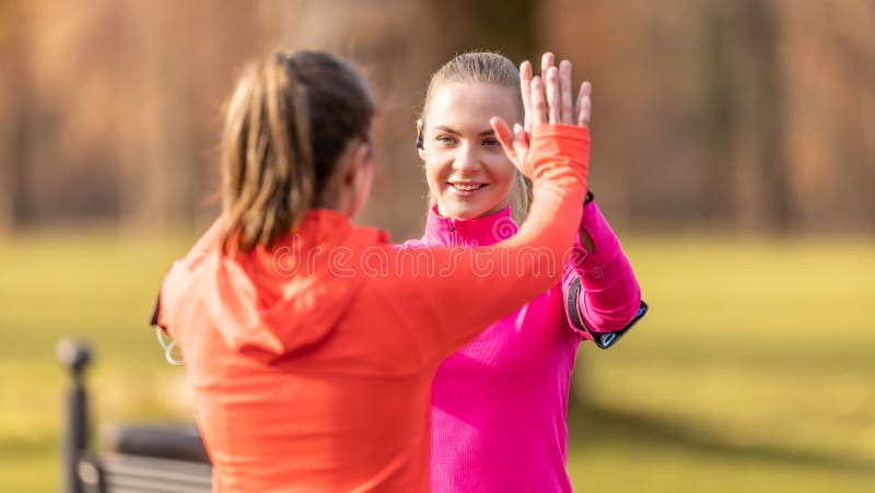 Two Female Athlete Friends Support Each Other and Give High-five after ...