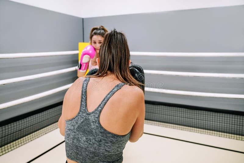 Two Female Boxers Fighting in a Boxing Practice on Top of a Ring Stock ...