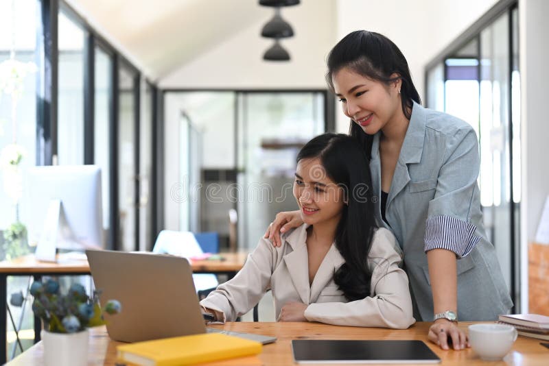 Two Female Business Colleagues Discussing Business Plan, Sharing ...