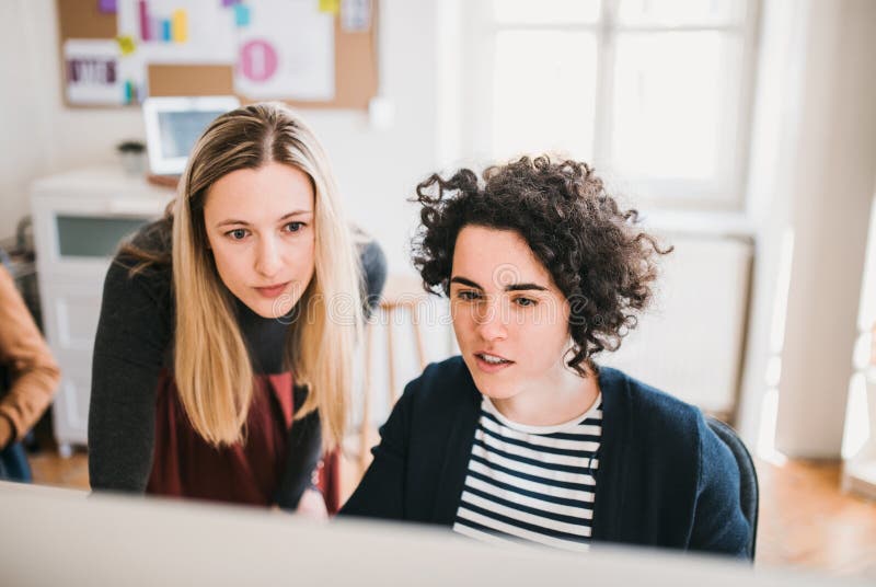Two Female Business People with Computer in a Modern Office, Working ...