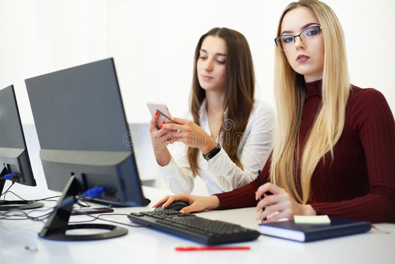 Two Female Colleagues in Office Working Together. Two Female Colleagues ...