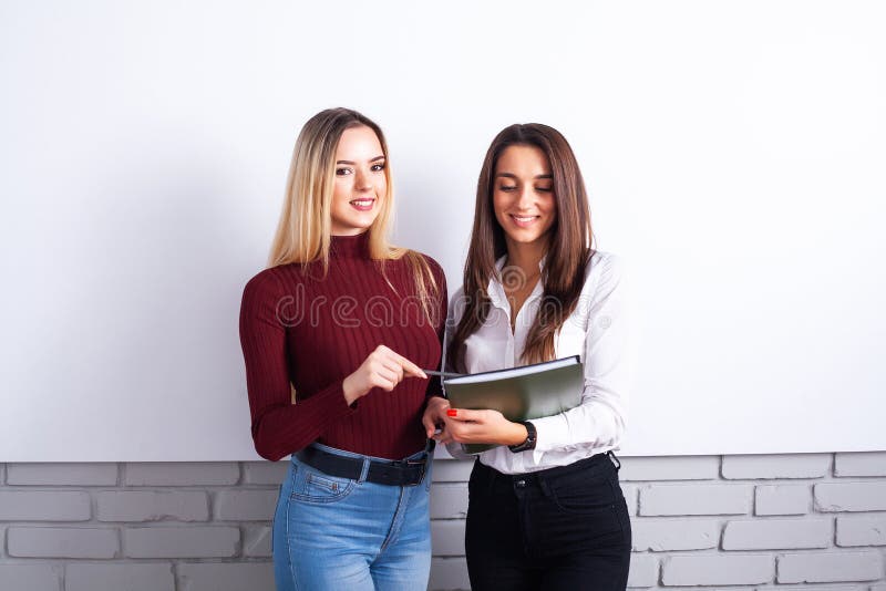 Two Female Colleagues in Office Working Together. Two Female Colleagues ...