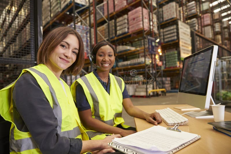 Two Female Colleagues in a Warehouse Office Look To Camera Stock Image ...
