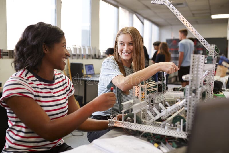 Two Female College Students Building Machine in Science Robotics or ...