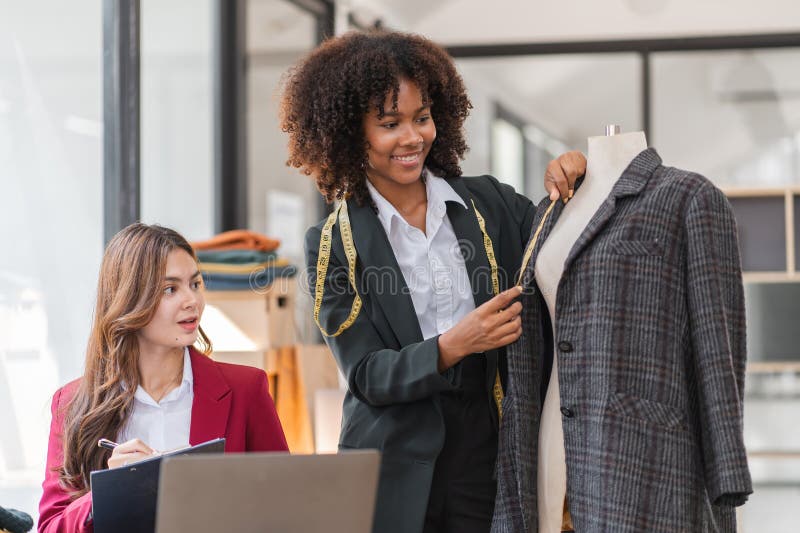 Two Female Designers Collaborating on Shirt Designs in a Modern Studio ...