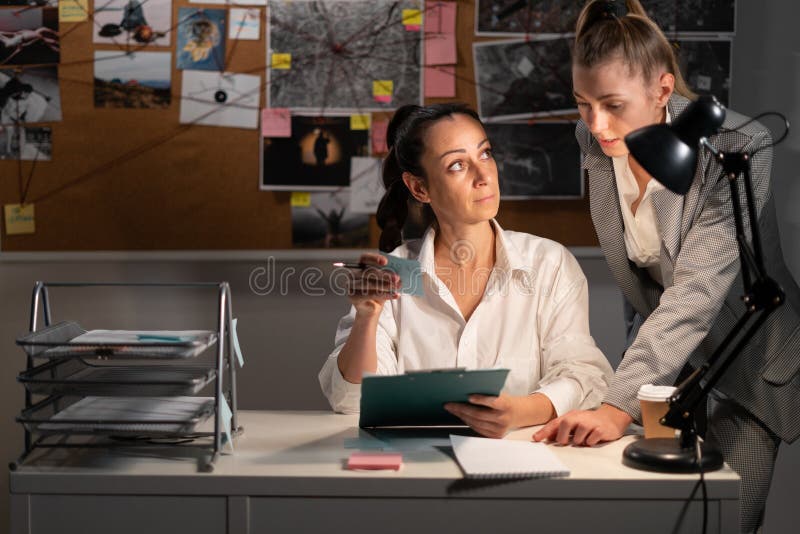 Two Female Detective Working at Desk in Her Office Stock Photo - Image ...