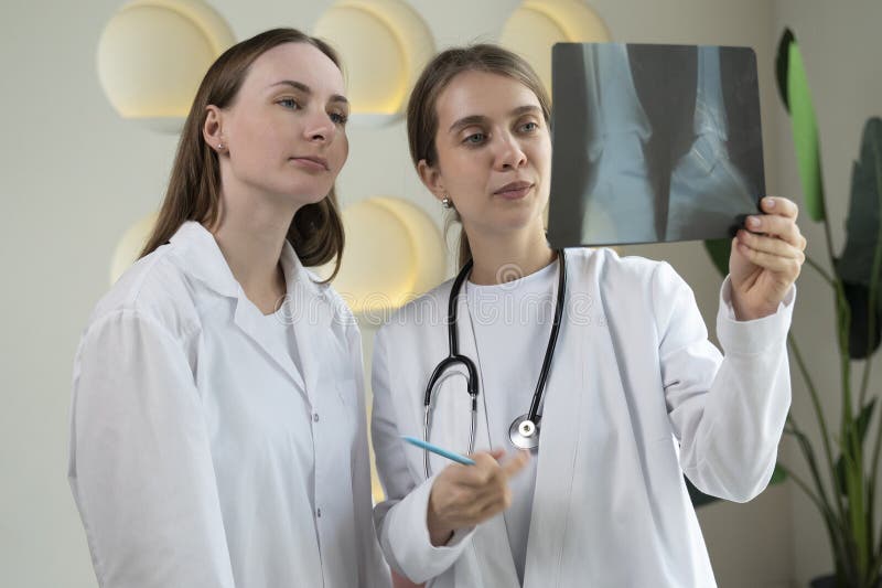 Two Female Doctors Look at the Patient S X-ray in the Clinic. Stock ...