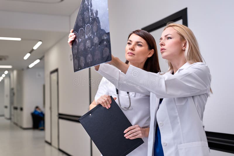 Two Female Doctors Looking at Biomedical Algorithm Screen and Machine ...