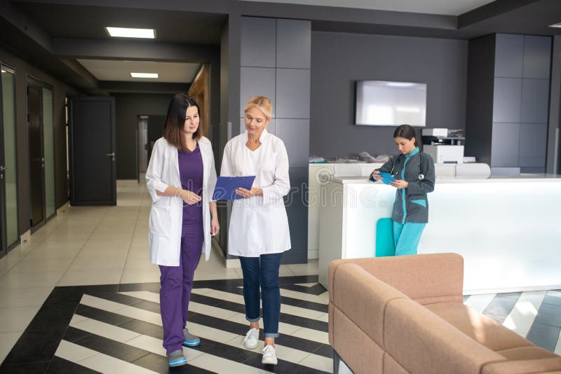 Two Female Doctors Walking in the Clinic Corridor Stock Image - Image ...