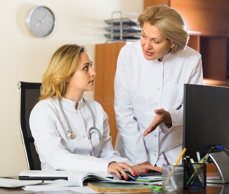 Two Female Doctors Working Together Stock Image - Image of clinic ...