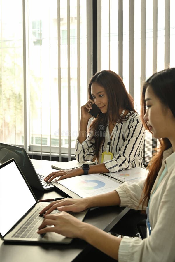 Two Female Employees Working Together in Office. Stock Photo - Image of ...