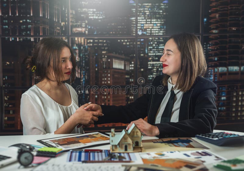 Two Female Engineers Working Together with House Interior Blueprint at ...