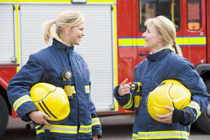Two Female Firefighters by a Fire Engine Stock Photo - Image of ...