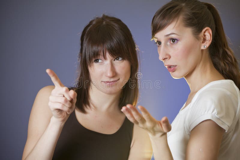Two Female Friends Discussing Stock Photo - Image of pointing, females ...