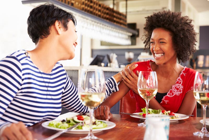 Two Female Friends Eating at a Restaurant Stock Photo - Image of ...