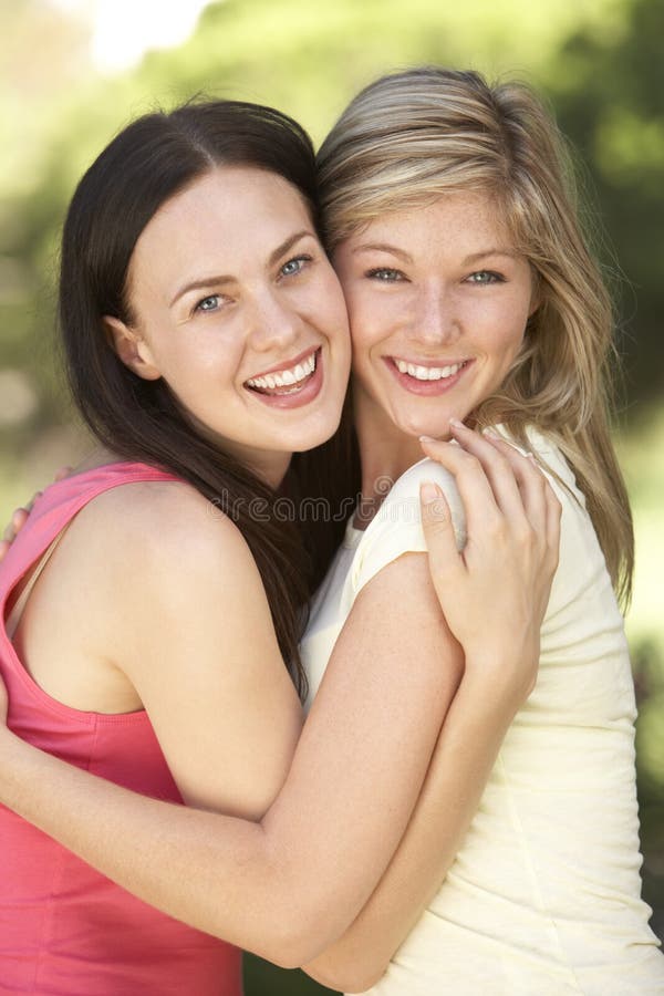 Two Female Friends Relaxing Together Stock Image - Image of holding ...