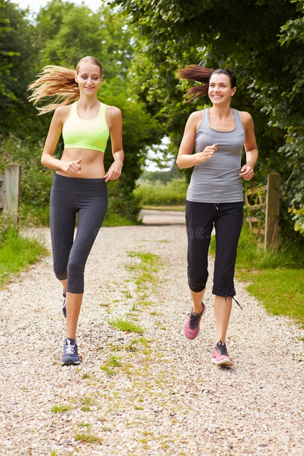 Two Female Friends on Run in Countryside Together Stock Image - Image ...