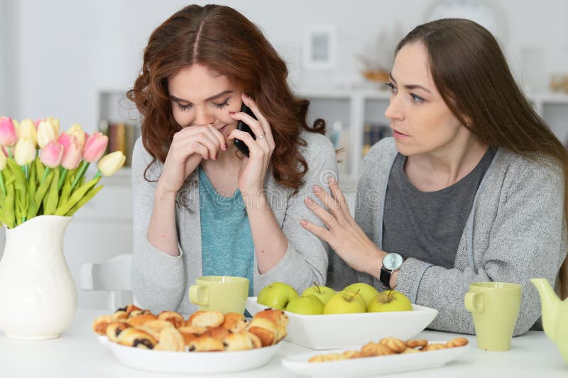 Portrait of Two Female Friends Sitting at Table and Drinking Tea Stock ...