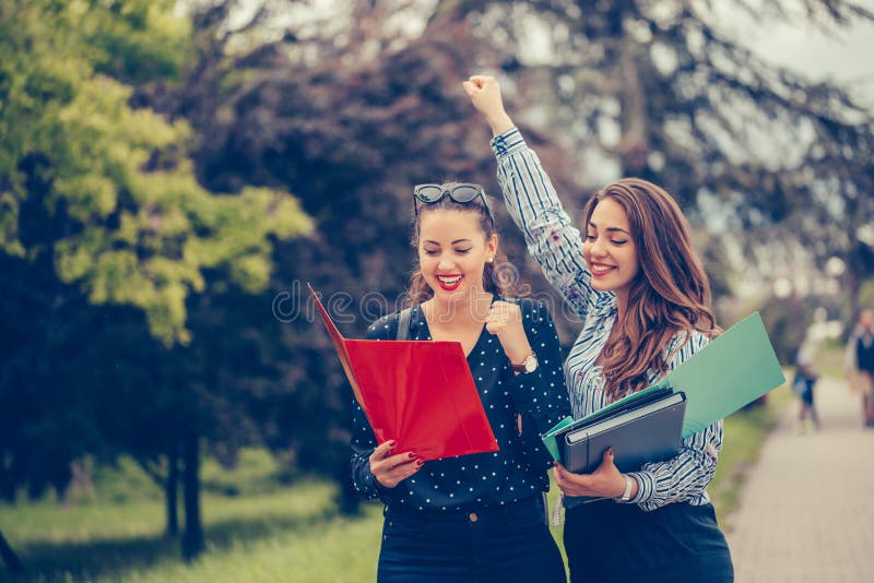Two Female Friends, Students Celebrating Success in a Park Stock Image ...