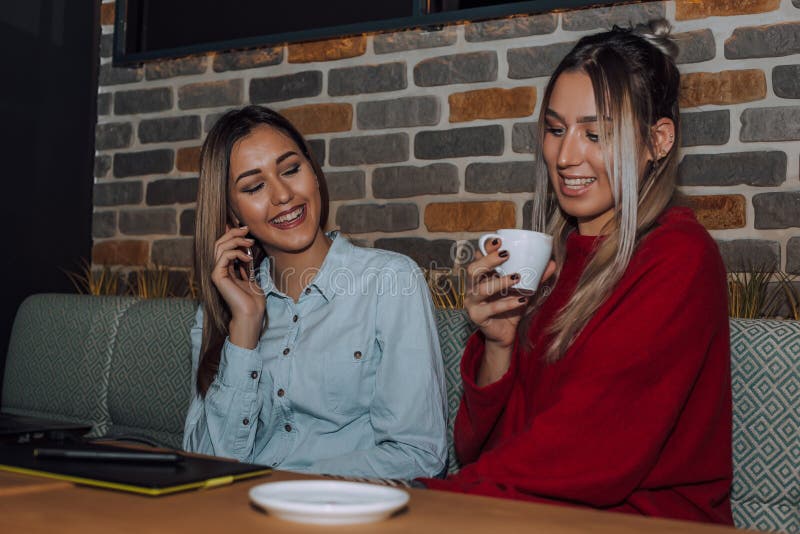 Two Female Friends Talking and Drinking Coffee in Cafe Stock Image ...