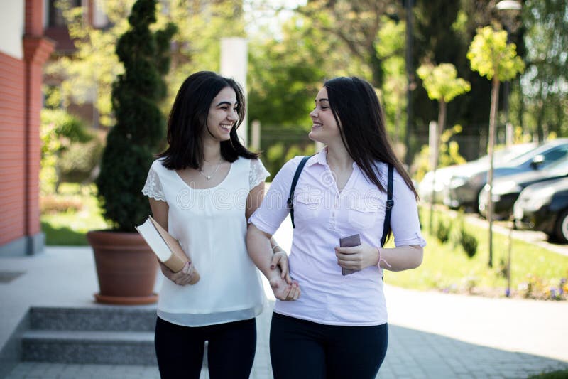 Two Female Friends Walking Around the University Campus Stock Photo ...