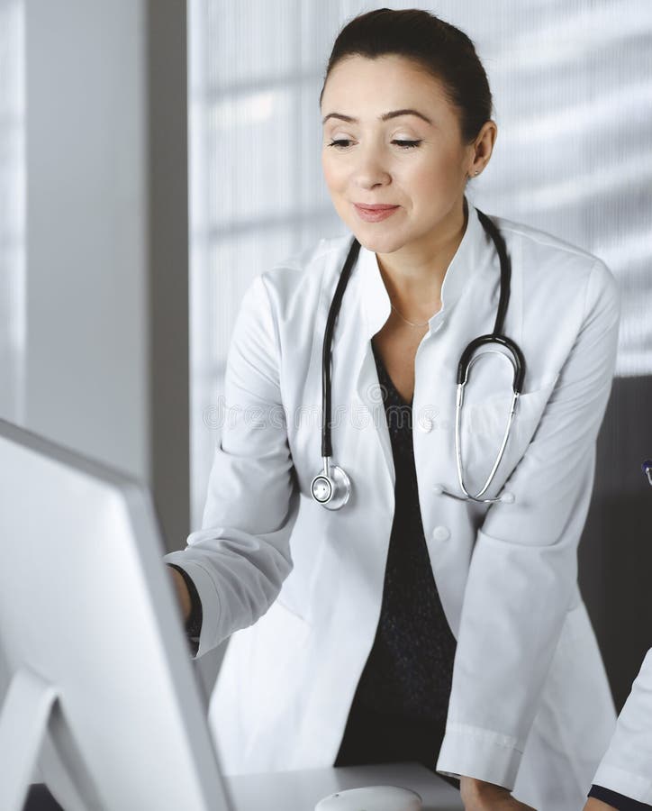 Two Female Physicians are Discussing Medical Therapy, while Standing at ...