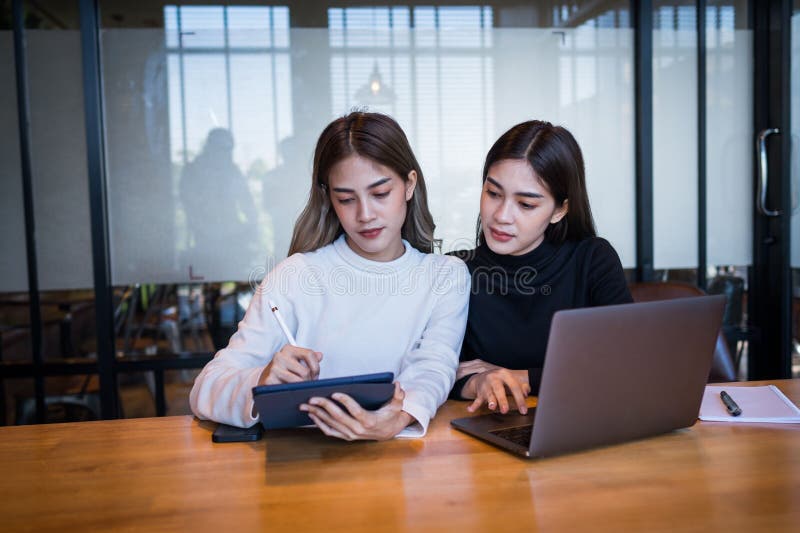 Two Woman Professionals Working Together in a Collaborative Workspace ...