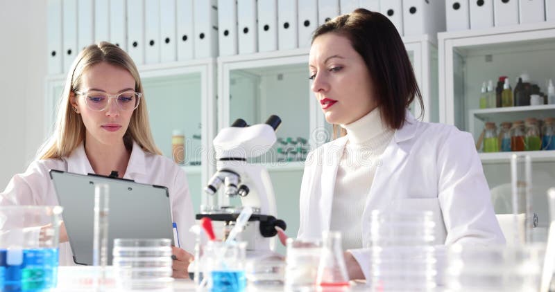 Two Female Scientists are Together in the Laboratory and Discussing a ...