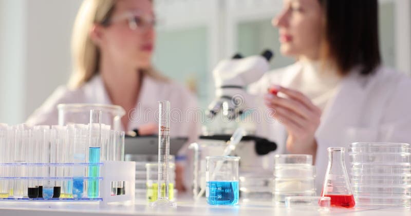 Two Female Scientists Working in a Laboratory and a Scientist is ...