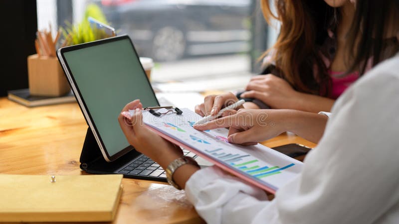 Two Female Students Doing Their Group Assignment Together with Document ...