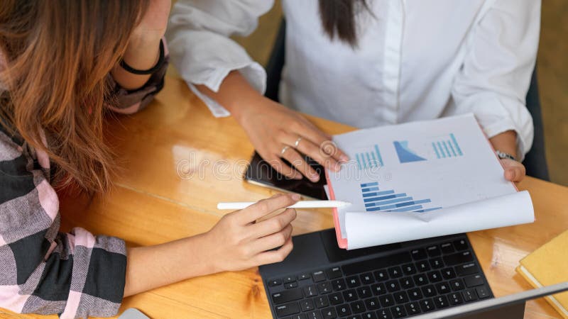 Two Female Students Doing Their Group Assignment Together with Document ...