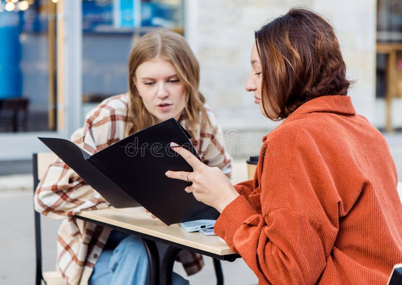 Two Female Students Sitting Table Outside Discussing Their Studies ...