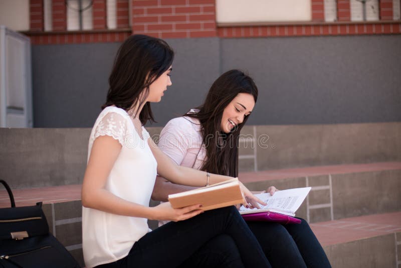 Two Female Students Studying, Preparing for Exams Together Outdoors ...