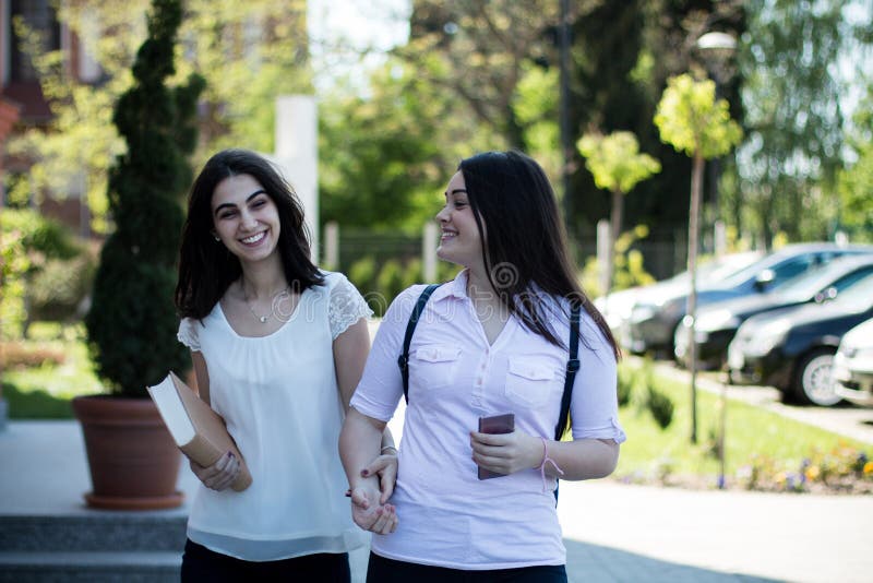 Two Female Students Walking Together on the Campus Stock Photo - Image ...