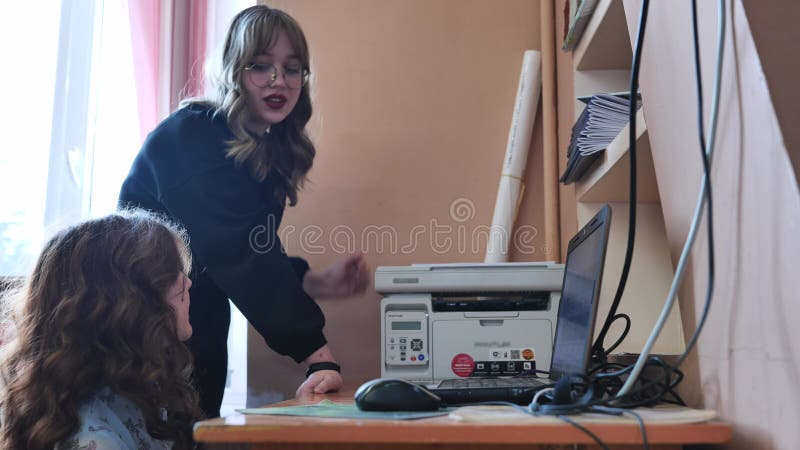 Two Female Students are Working at a Computer in a Classroom at School ...