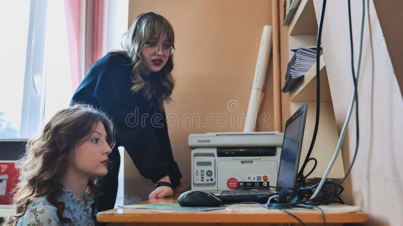 Two Female Students are Working at a Computer in a Classroom at School ...