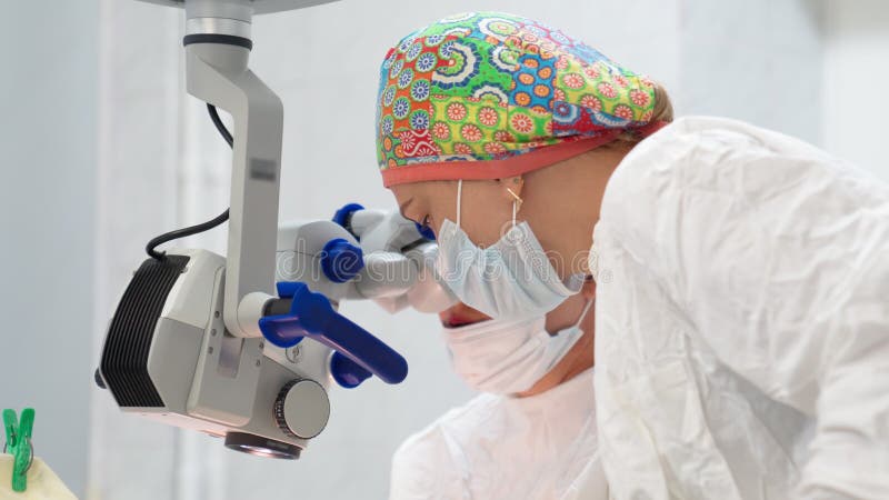 Two Female Surgeons Perform Eye Surgery with Microscope and Medical ...