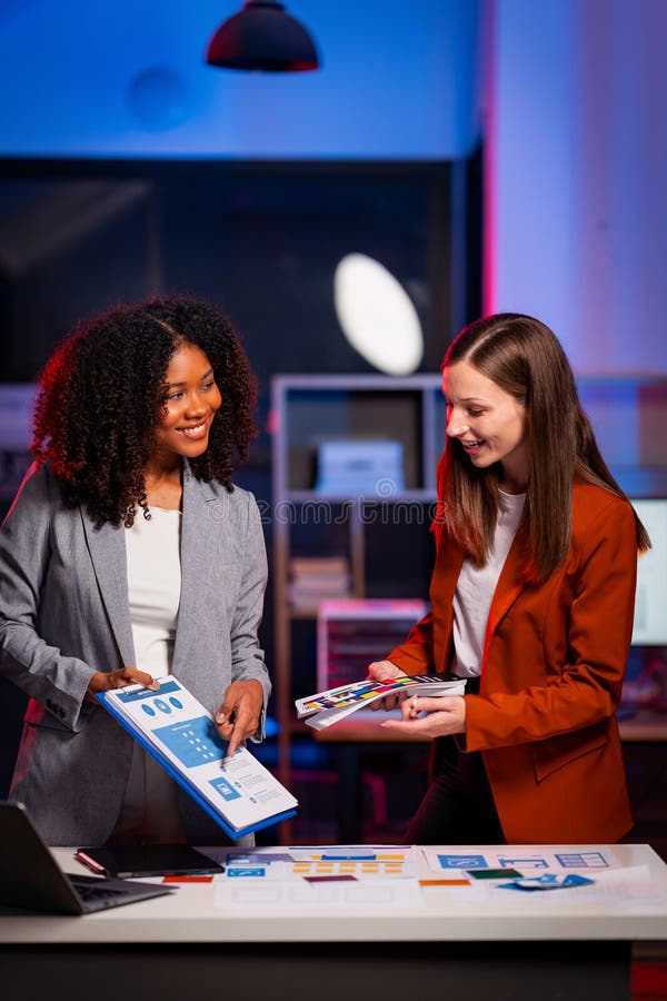 Two Female UI UX Designers Work Together To Talk about Designing Mobile App Interfaces on Both ...