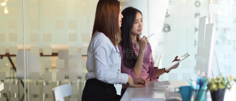 Two Female Worker Consulting on Their Project in Modern Meeting Room ...