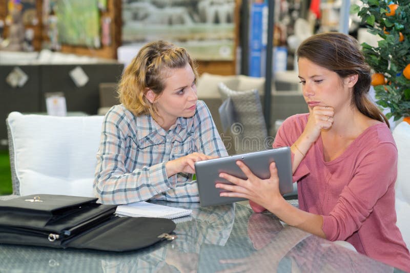 Two Female Workers Holding Tablet Stock Photo - Image of friends ...