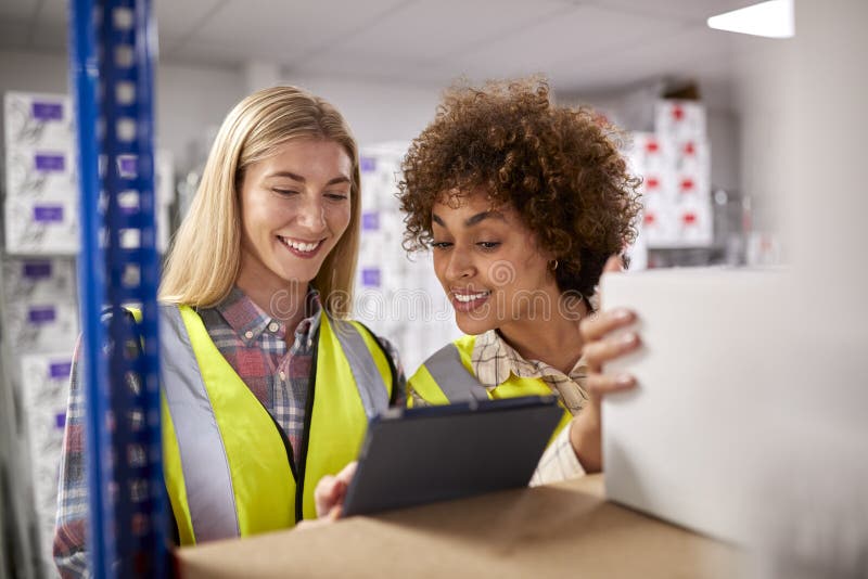 Two Female Workers in Logistics Distribution Warehouse Using Digital ...