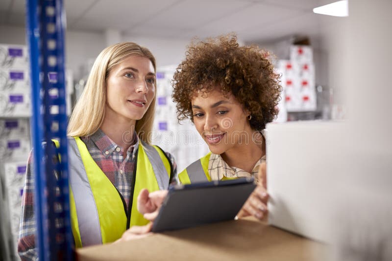 Two Female Workers in Logistics Distribution Warehouse Using Digital ...